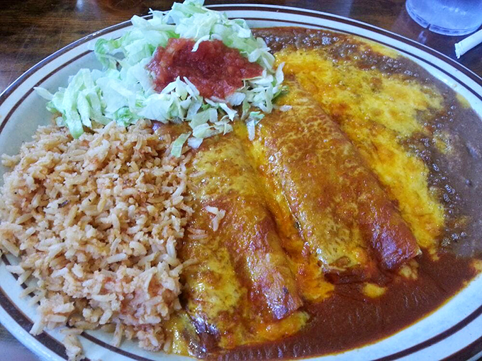 These enchiladas aren't just served&mdash;they're presented with pride, swimming in rich sauce alongside perfectly executed rice and beans.