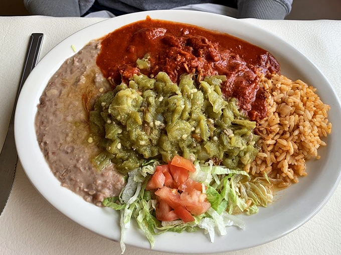 The holy trinity of New Mexican dining: red chile, green chile, and perfectly cooked beans. This plate doesn't need a filter to be Instagram-worthy.