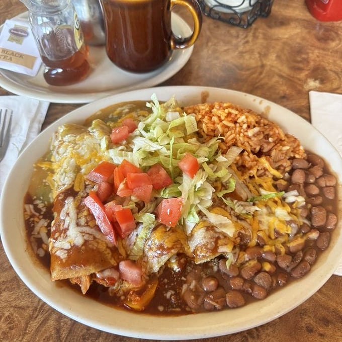 Christmas-style enchiladas that make choosing between red and green chile unnecessary&mdash;like having your cake and eating it too, except it's smothered in melty cheese and comes with beans.