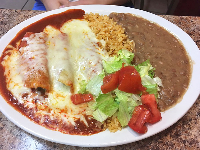 Enchiladas draped in that perfect red sauce with cheese melted just right. The rice and beans aren't sidekicks &ndash; they're co-stars in this delicious production.