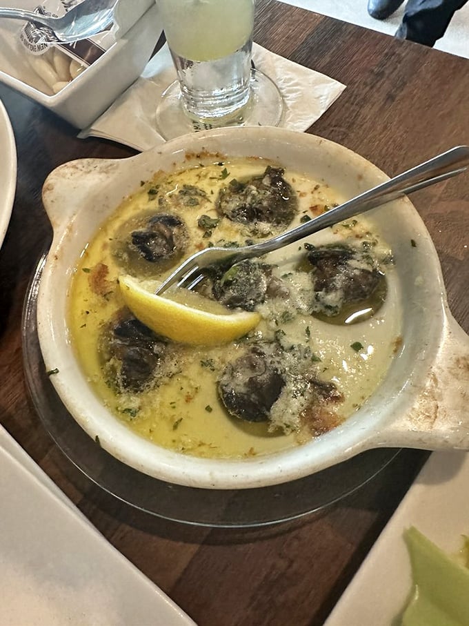 Escargot swimming in garlic butter so good you'll contemplate drinking it like soup when no one's looking. The lemon wedge is just a formality.