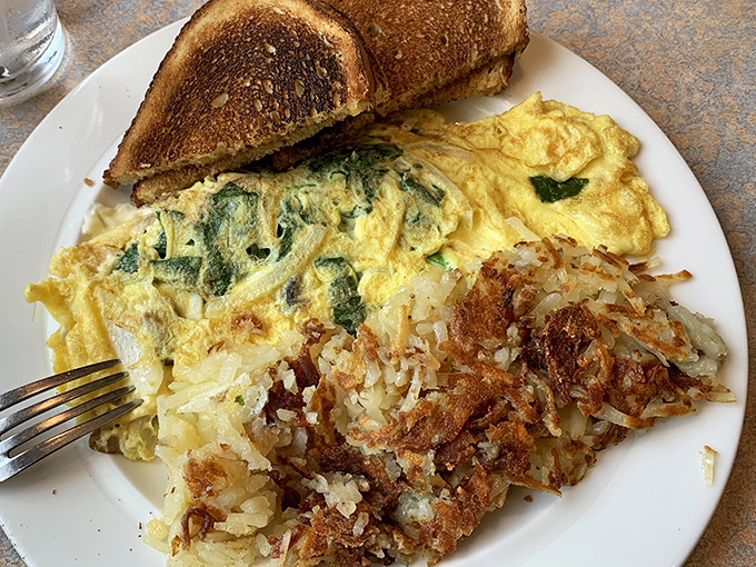 This spinach omelet with perfectly crispy hash browns isn't just breakfast &ndash; it's edible sunshine that makes Monday mornings bearable again.