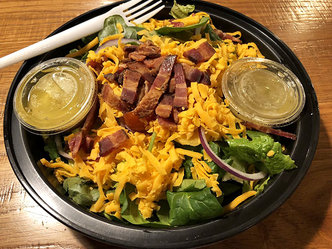 This isn't just any salad; it's a crunchy, cheesy celebration topped with perfectly crisp bacon that might make you forget you came for pizza.