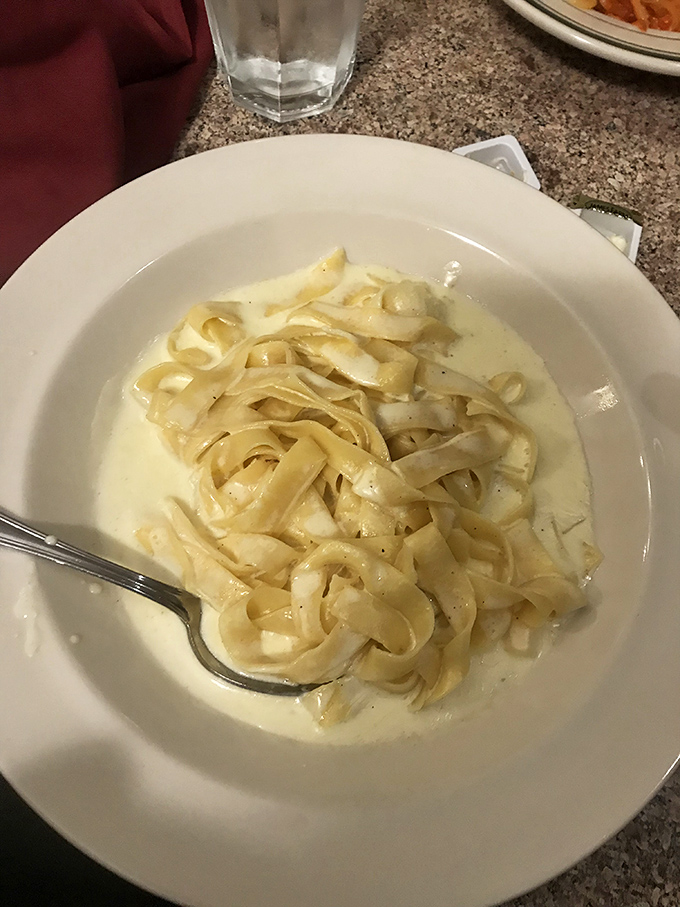 Fettuccine Alfredo so creamy it should be illegal, with ribbons of pasta swimming in a sauce that would make Romans weep with joy.