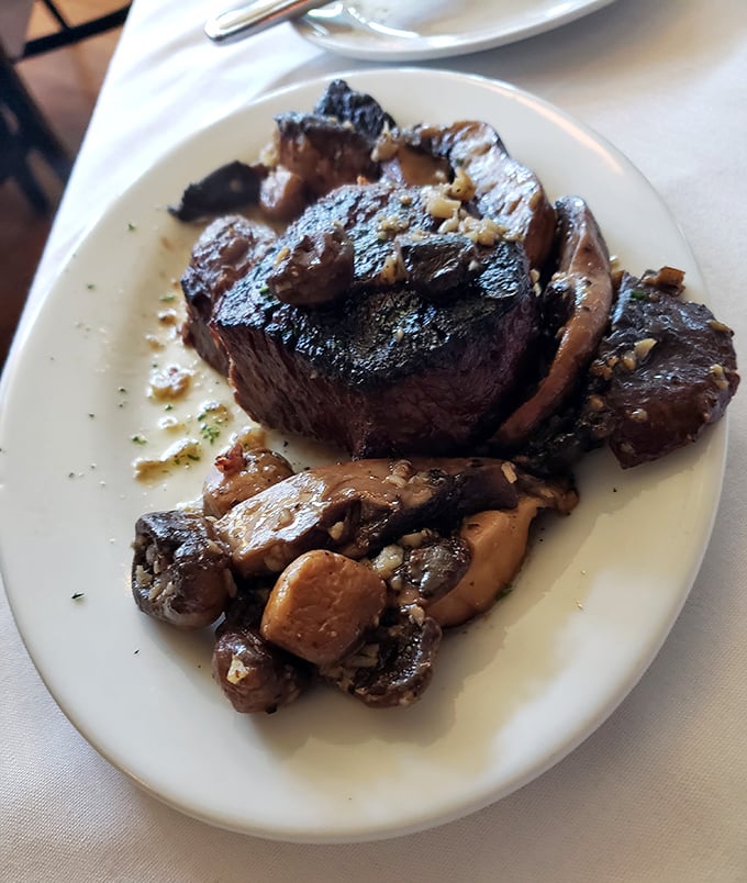 That's not just a steak; it's a sculpture of carnivorous perfection with a supporting cast of mushrooms that clearly got the memo.
