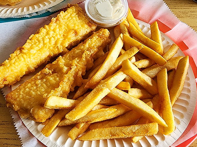 Golden-battered fish alongside perfectly crisp chips &ndash; this isn't just food, it's edible sunshine that makes you want to hum "Rule, Britannia" between bites.