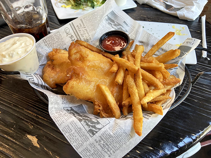Behold the star attraction: golden-battered fish with perfectly crisp fries, served on newspaper like the British gods intended.
