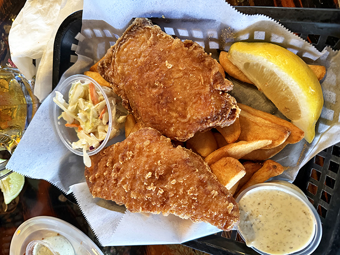 Golden-battered fish that shatters with each bite, served with crispy fries, tangy slaw, and a lemon wedge for that perfect squeeze of sunshine.