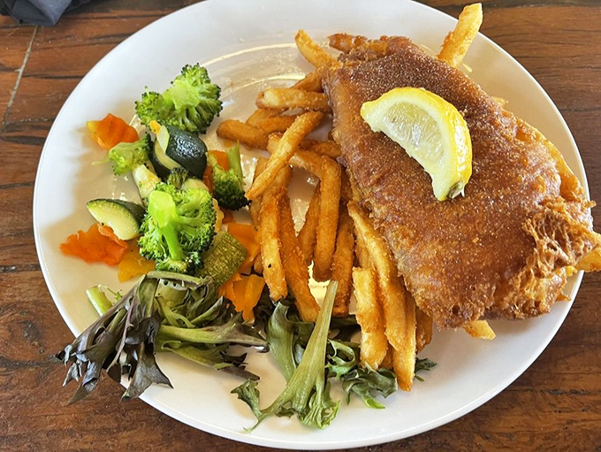 Golden-battered fish that shatters like glass, fries that could make a Frenchman weep, and vegetables that aren't just an afterthought.