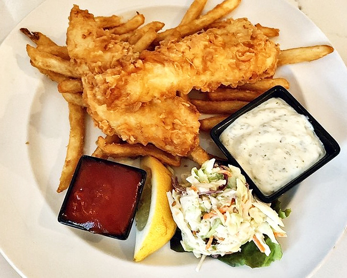 This isn't just fish and chips&mdash;it's edible architecture: golden-battered cod perched atop hand-cut fries with house-made tartar sauce.