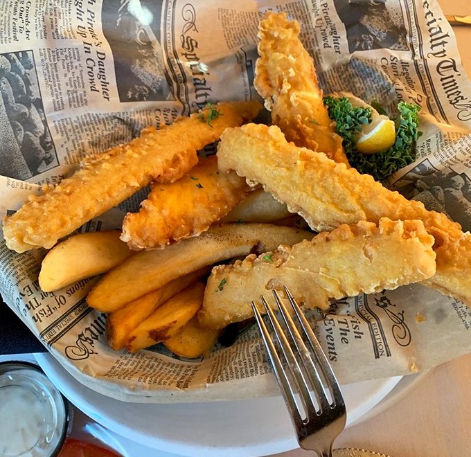 Golden-battered fish and chips served on newspaper—a delicious reminder that sometimes the simplest traditions make the most profound statements.