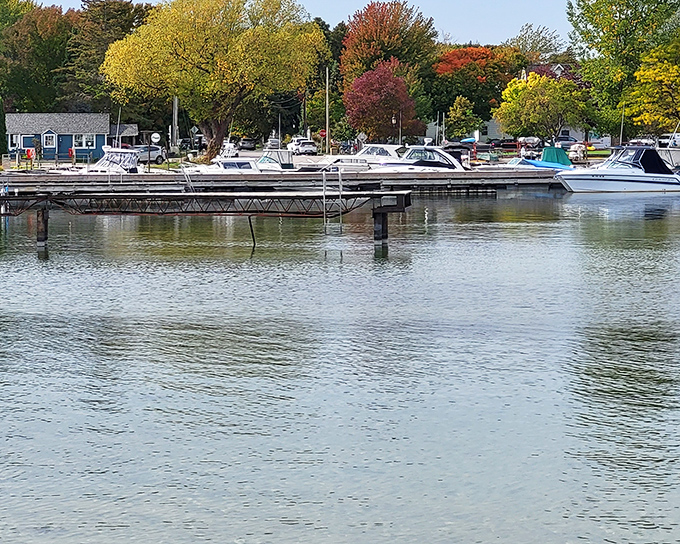 Fall paints Fish Creek Marina in nature's most extravagant palette, where boats rest peacefully against a backdrop that no filter could improve.