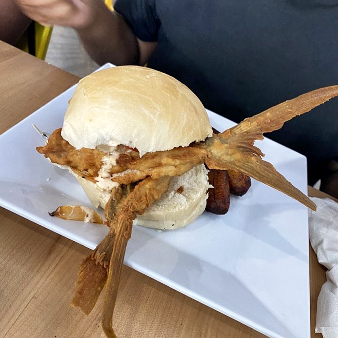 The legendary Pan con Minuta arrives with its tail intact&mdash;nature's way of saying "I was swimming this morning." Cuban bread cradles fried perfection in Miami's most iconic sandwich.
