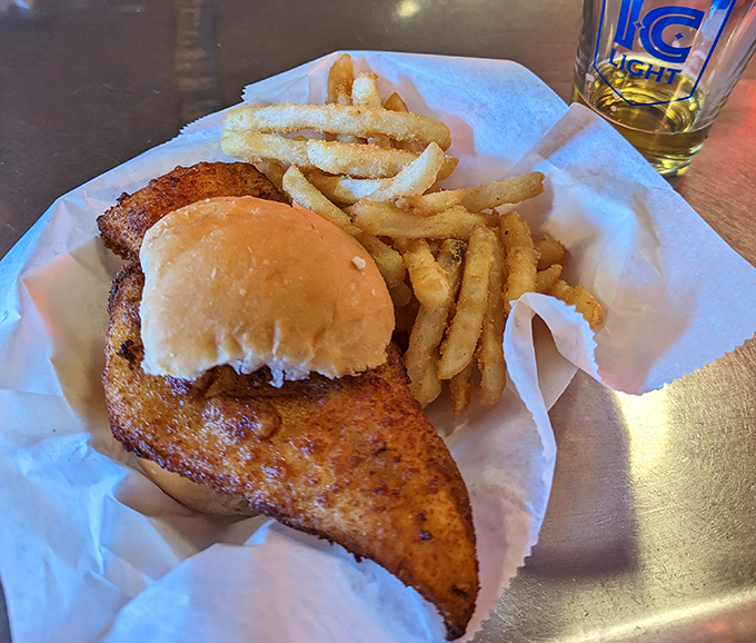 The legendary fish sandwich in all its glory&mdash;where the fish boldly declares independence from the bun's boundaries. This isn't food; it's edible architecture.