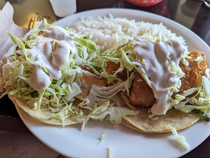 These fish tacos aren't just food&mdash;they're an event. Crispy battered fish, mountain of cabbage, and that sauce that dreams are made of.
