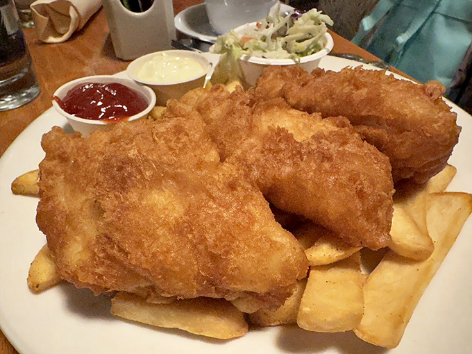 Golden-battered fish perched atop a mountain of crispy fries&mdash;this isn't just fish and chips, it's edible sunshine with a side of coastal bliss.