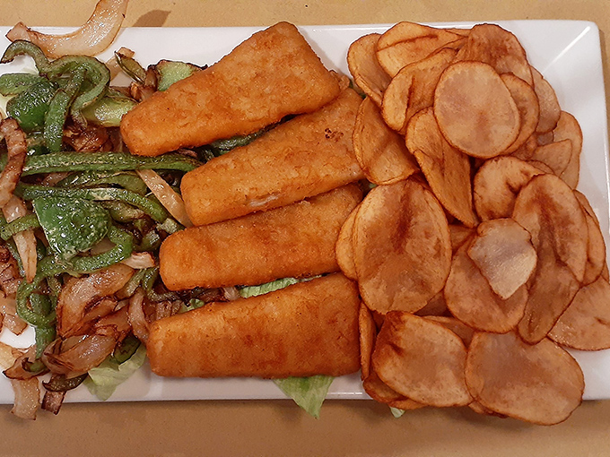 Golden-battered fish fillets with homemade chips and saut&eacute;ed vegetables&mdash;proof that perfection doesn't need reinvention, just respect for tradition and technique.