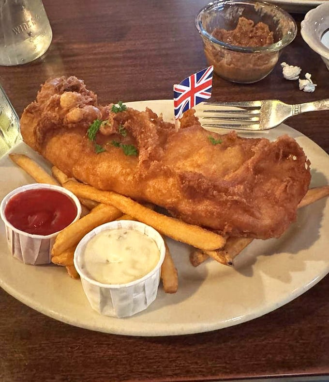 This isn't just fish and chips; it's edible British patriotism complete with a Union Jack flag standing tall in golden, crispy perfection.