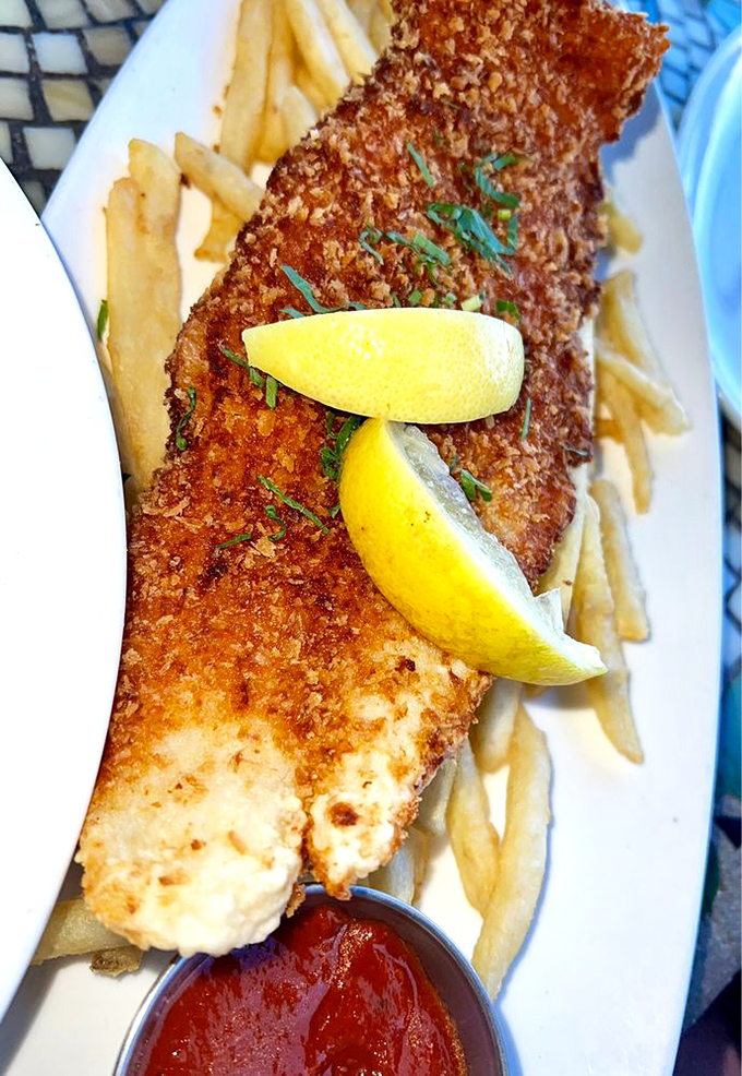 Golden-brown perfection that shatters at first bite, revealing flaky white fish beneath. The lemon wedge isn't just garnish &ndash; it's the perfect acidic counterpoint to this crispy masterpiece.