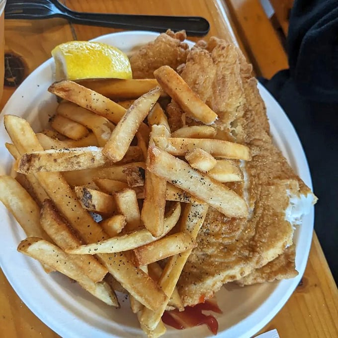 Golden-battered fish that breaks apart with the gentlest fork pressure, paired with fries that deserve their own fan club.