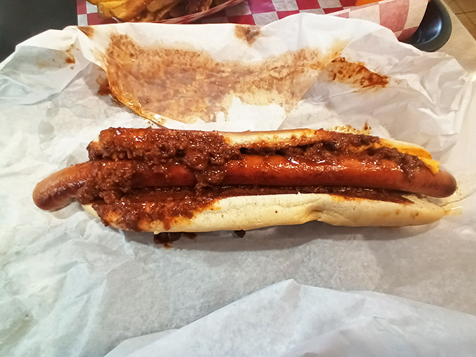 Behold the chili cheese foot-long in all its messy glory – a hot dog that requires strategy and multiple napkins.