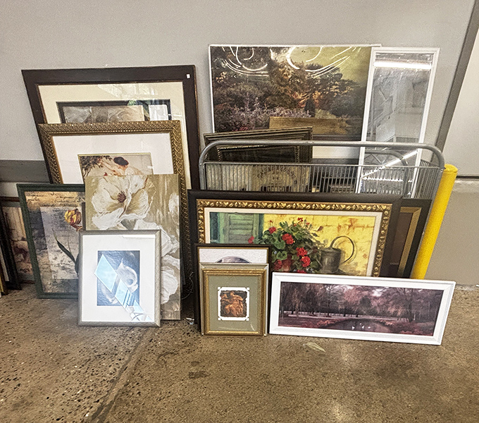 Wall art galore waiting for its forever home. One person's discarded landscape is another's living room masterpiece.