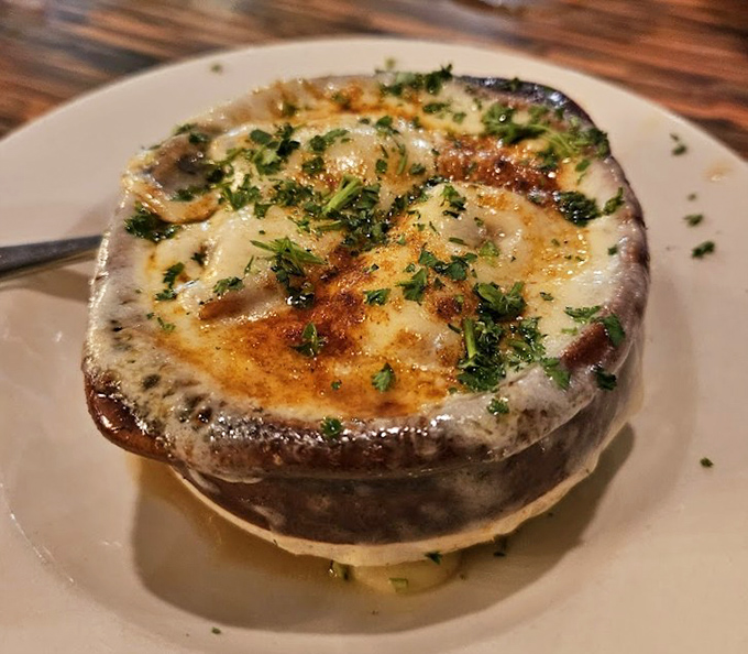 The French onion soup arrives like a cheese volcano waiting to erupt with flavor &ndash; this isn't just soup, it's an event.