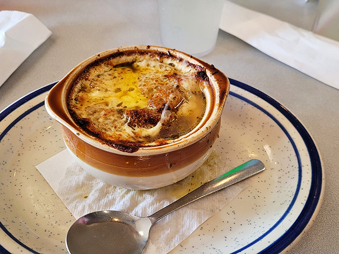 French onion soup that's had a proper education in caramelization. That cheese pull would make a pizza commercial jealous.