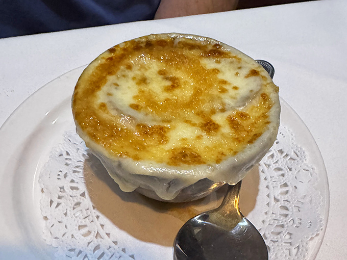 The French onion soup arrives like a work of art &ndash; that golden, bubbling cheese canopy hiding a treasure of caramelized onions and rich broth below.