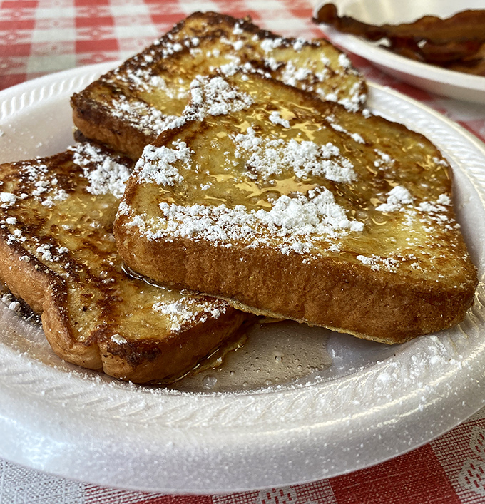 Golden, perfectly caramelized French toast dusted with powdered sugar. This isn't just breakfast&mdash;it's the reason alarm clocks were invented.