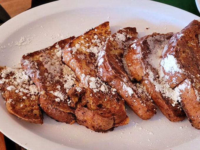 Golden-brown perfection! Shakabrah's legendary French toast arrives dusted with powdered sugar, crispy outside and custardy within&mdash;breakfast nirvana on a plate.