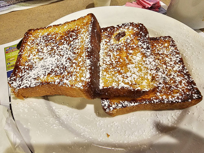 French toast that's achieved golden-brown perfection, dusted with powdered sugar like the first perfect snowfall of winter. Simple, classic, irresistible.