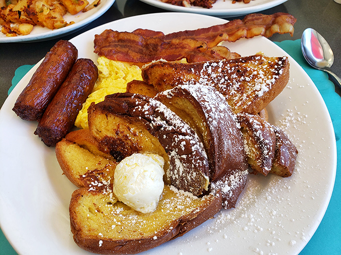 French toast that deserves its own Instagram account. Golden-brown perfection dusted with powdered sugar, served with a side of "why don't I make this at home?" regret.