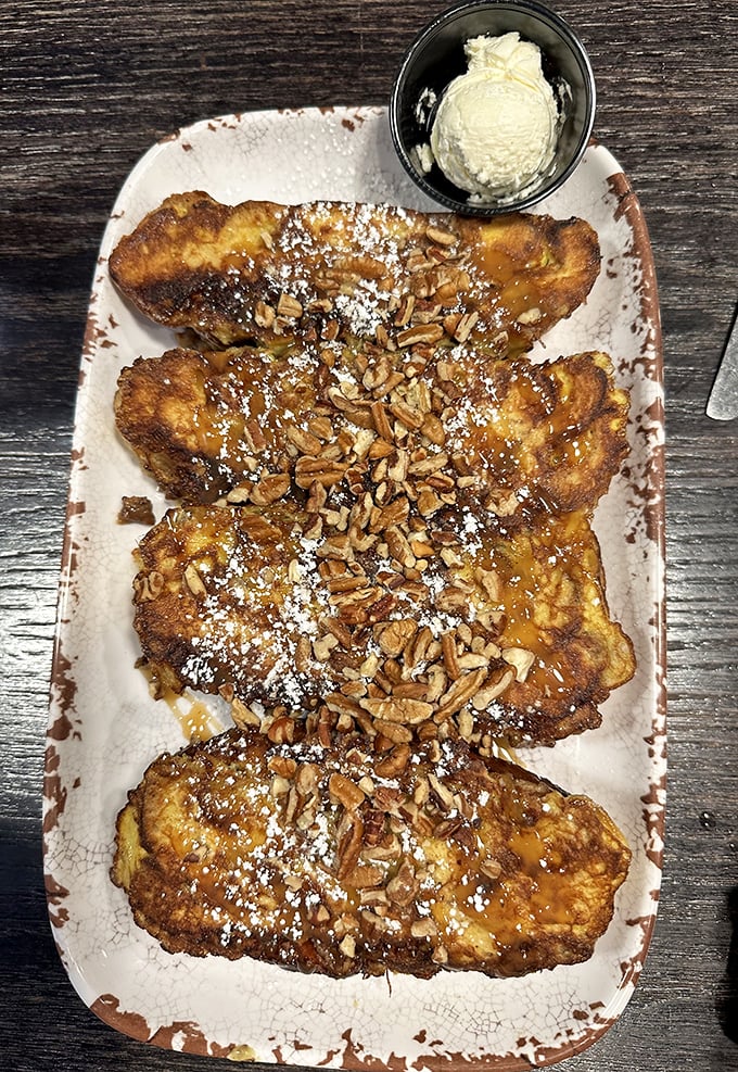 French toast nirvana achieved! Golden-brown perfection topped with candied pecans and a dusting of powdered sugar &ndash; breakfast doesn't get more photogenic than this.