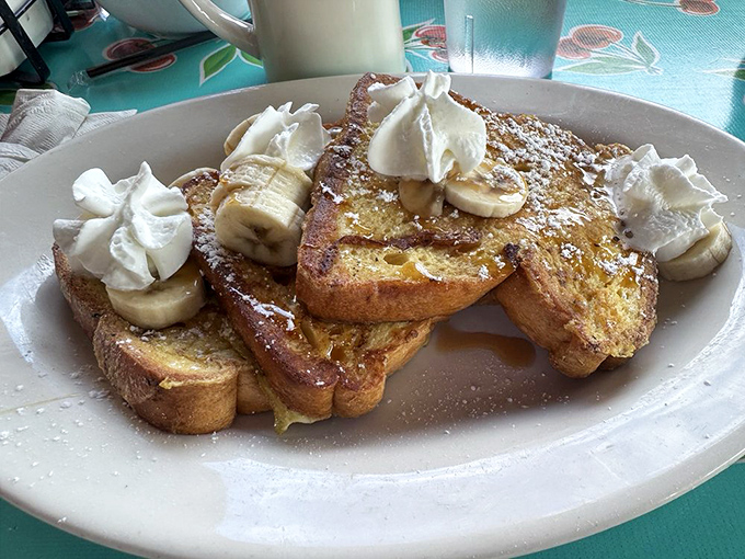 French toast that makes you question every other breakfast you've ever had. Golden, custardy perfection topped with fresh bananas and whipped cream.