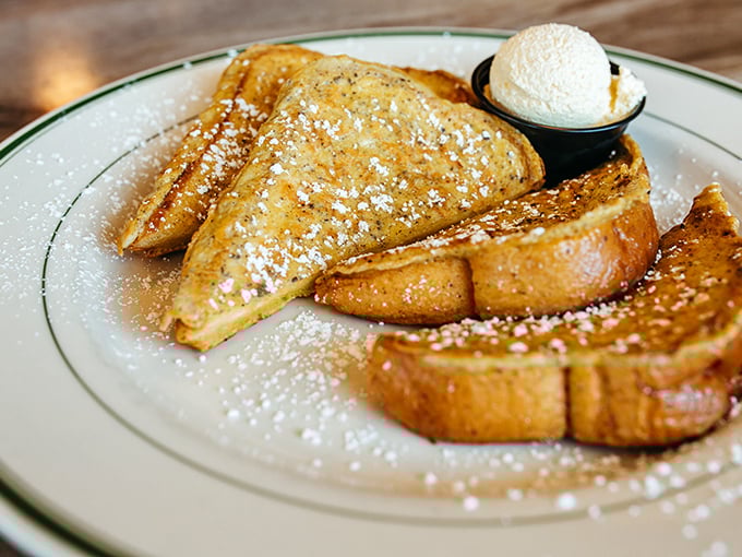 Golden-brown French toast dusted with powdered sugar snow &ndash; breakfast architecture so perfect it deserves its own HGTV special.
