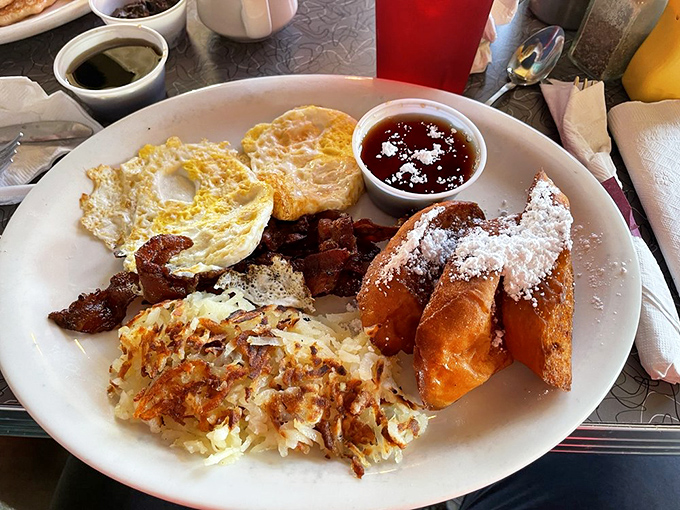 Breakfast perfection doesn't happen by accident. This plate combines crispy hash browns, perfectly fried eggs, and French toast dusted with powdered sugar&mdash;the breakfast equivalent of a standing ovation.