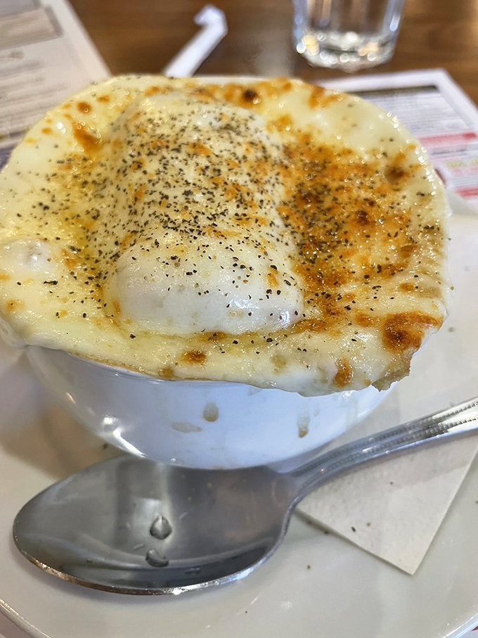 French onion soup that's achieved the impossible: perfectly melted cheese that stretches dramatically with each spoonful. The soup equivalent of a standing ovation.