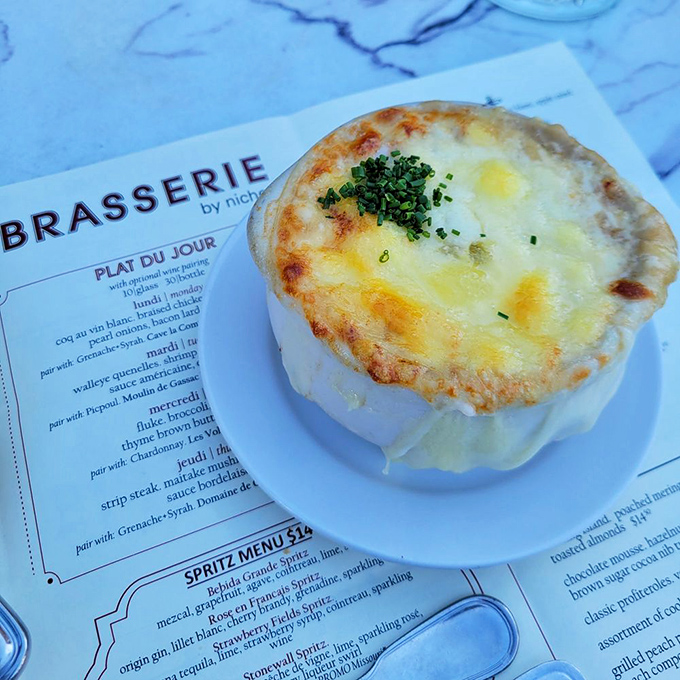 Bubbling cheese forms a golden canopy over this French onion soup. Breaking through that crust is like discovering buried treasure—except this treasure is deliciously edible.