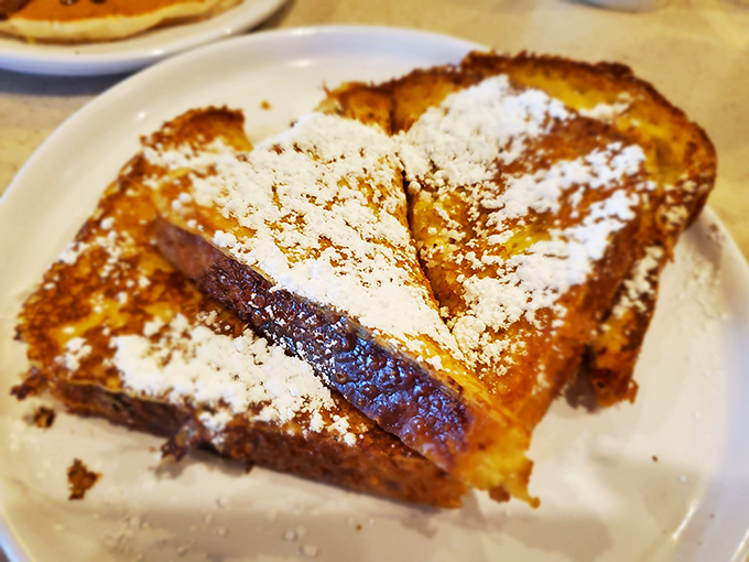 Golden-brown perfection dusted with powdered sugar—this French toast doesn't need elaborate toppings to make you question whether you've died and gone to breakfast heaven.