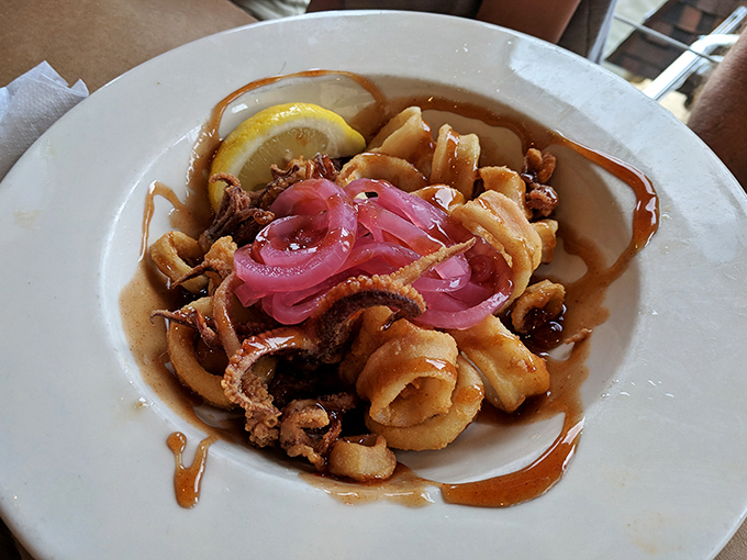 Cantler's calamari arrives tender, perfectly fried, and adorned with pickled onions. This isn't just appetizer territory&mdash;it's the reason some folks never make it to the entr&eacute;es.