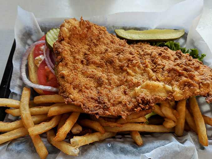 This isn't just fried catfish &ndash; it's a golden-armored delicacy that breaks apart with the gentlest pressure of a fork, surrounded by fries standing at attention.