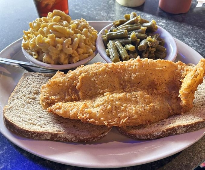 Golden-brown perfection served on white bread with mac and cheese and green beans&mdash;this is comfort food conducting a symphony.