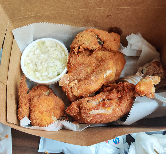 Golden-brown perfection in a takeout box. This isn't just fried chicken; it's edible sunshine with a side of nostalgia.