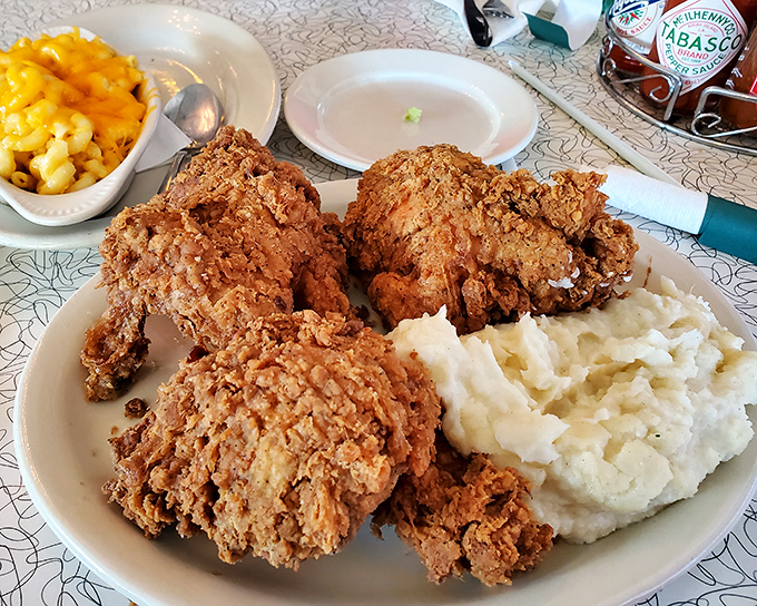 Golden-brown fried chicken that shatters with each bite, paired with creamy mashed potatoes and mac and cheese – the holy trinity of comfort food.
