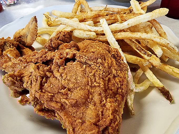 Golden-brown perfection meets crispy, crackling skin &ndash; this fried chicken with hand-cut fries might just be worth crossing state lines for.