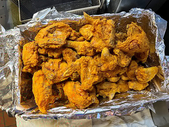 Golden-brown perfection piled high on foil. This isn't just fried chicken &ndash; it's edible Oklahoma history that makes your fingers glisten with delicious evidence.