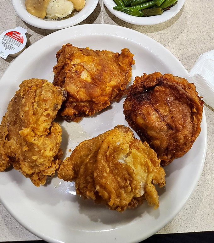 Golden-brown perfection that makes you understand why people drive for miles. This isn't just fried chicken; it's edible nostalgia with a side of joy.