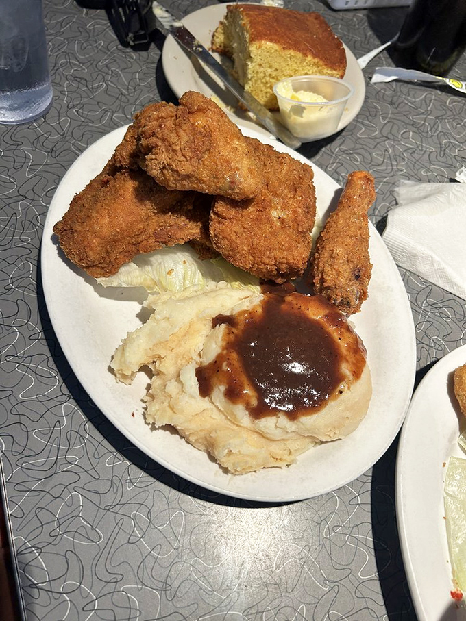 Fried chicken so perfectly golden, it makes Colonel Sanders look like he's still in basic training. Served with mashed potatoes drowning gloriously in gravy.