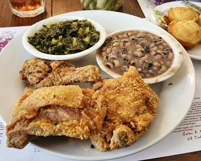 Golden-brown perfection meets Southern tradition. This fried chicken doesn't just speak to your stomach—it whispers to your soul with sides of collards and black-eyed peas.